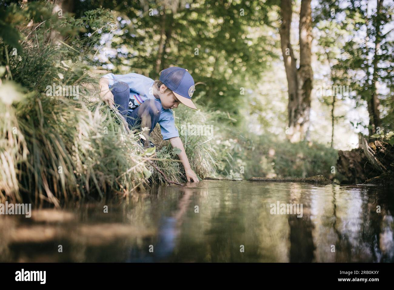 Boy playing by a stream Stock Photo - Alamy