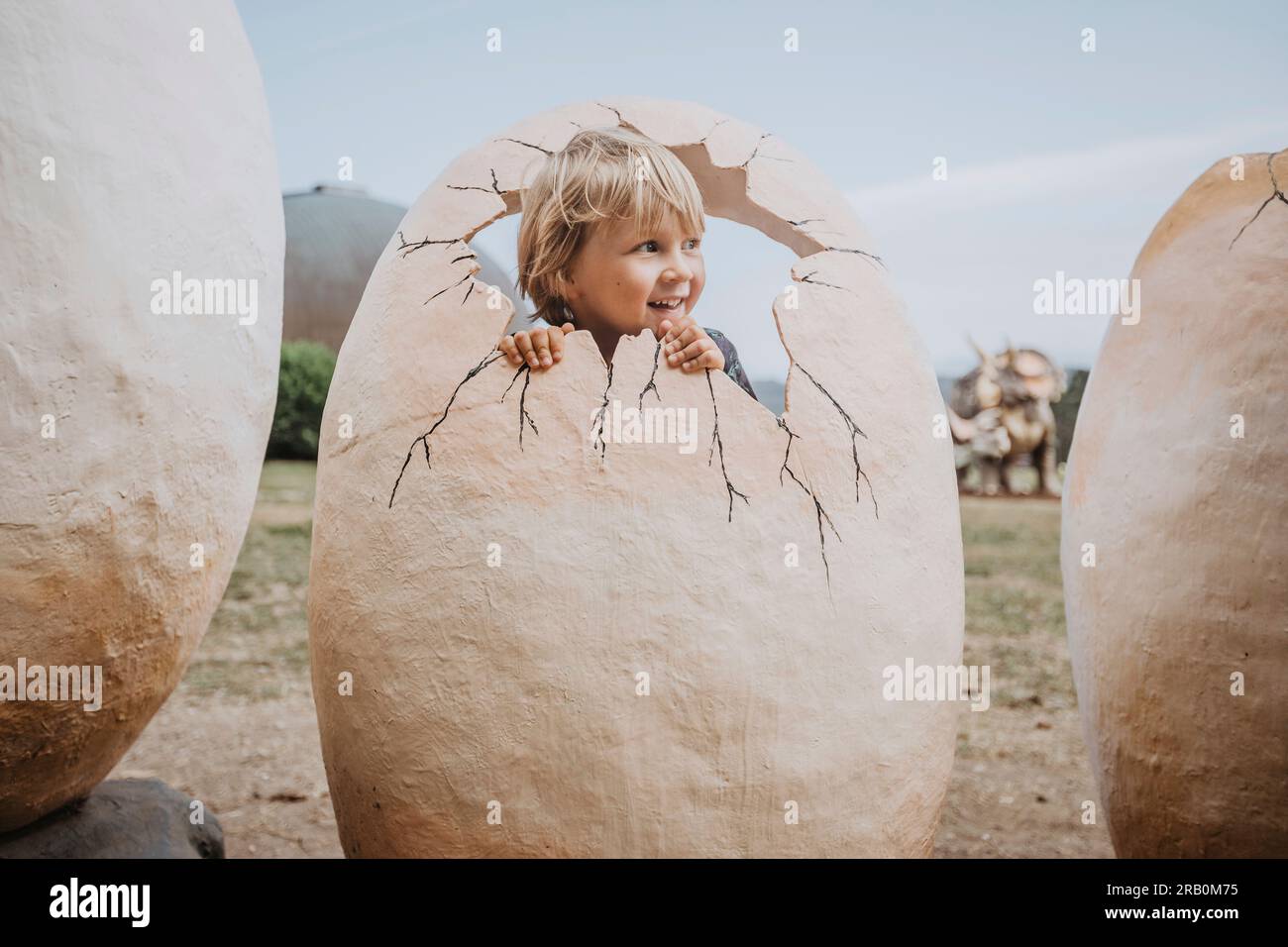 Boy looking out of sculpture of a dinosaur egg hi-res stock photography ... Boy looking out of sculpture of a dinosaur egg hi-res stock photography ...