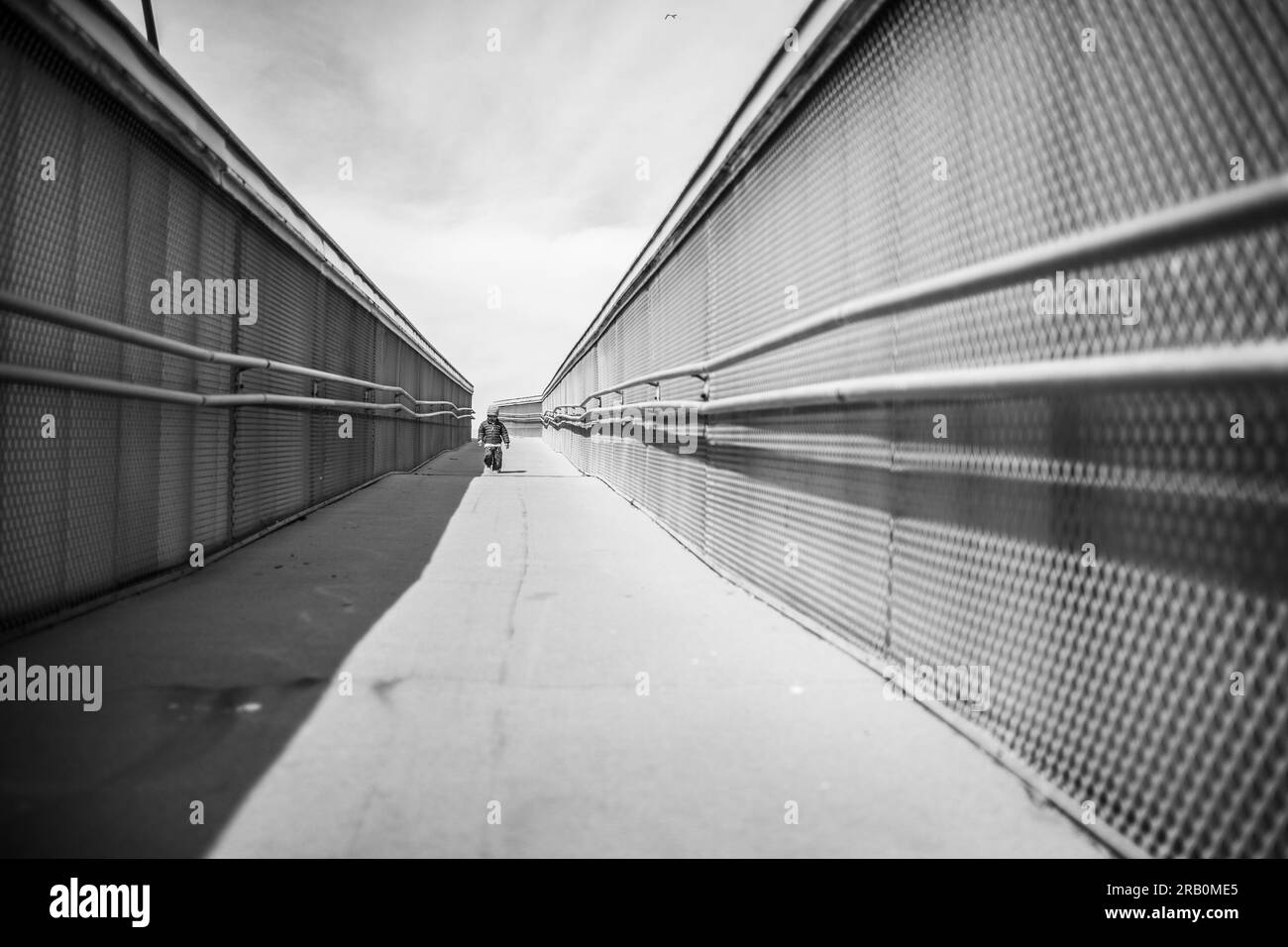 Boy running over a bridge Stock Photo - Alamy