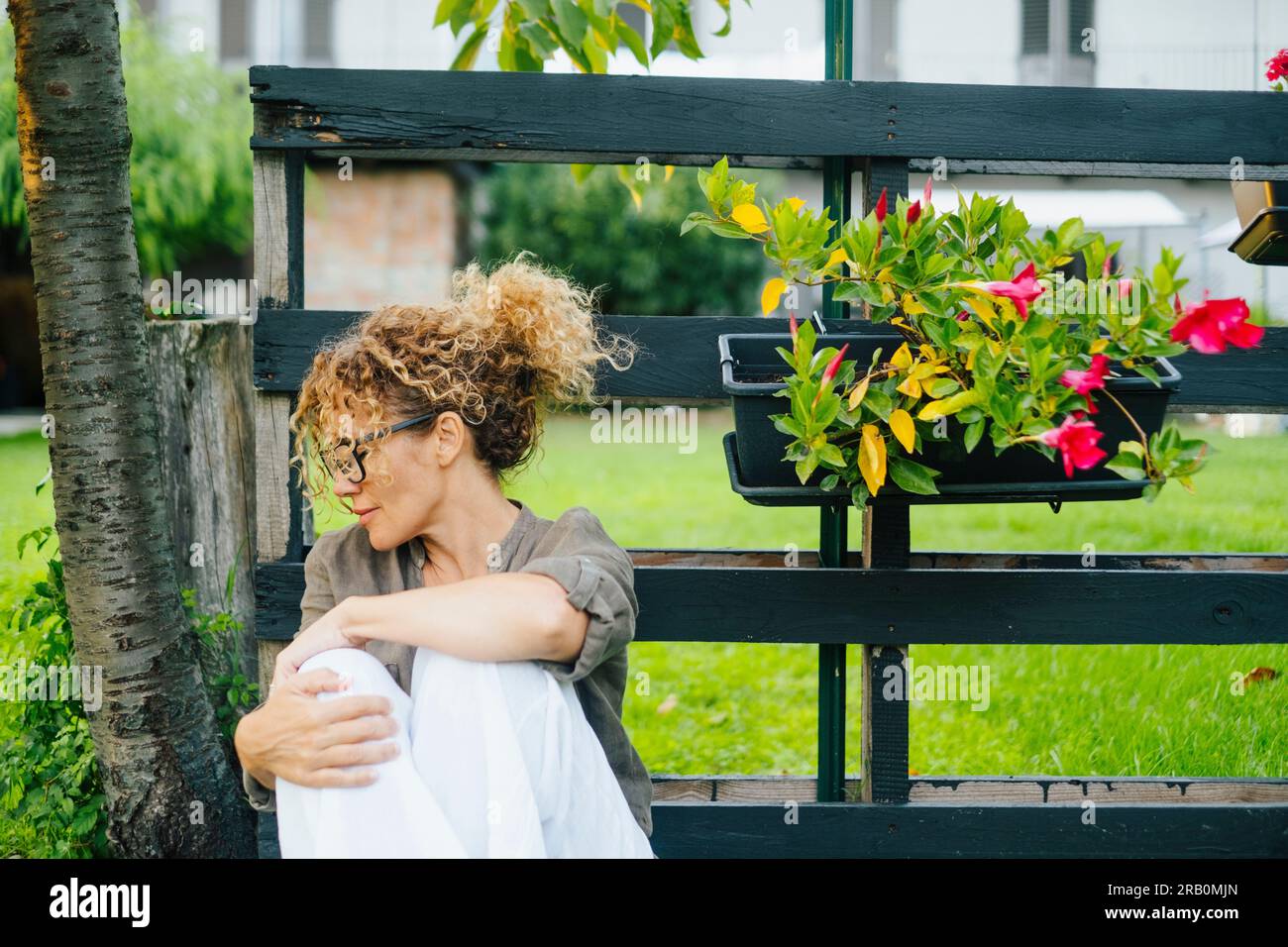 One lady outside home enjoy time and rela in green garden. Wellbeing ...
