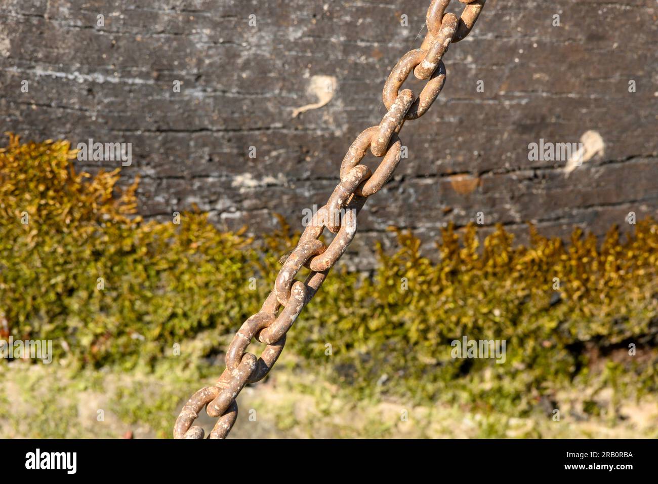 Rusty chain on an old wooden boat Stock Photo - Alamy