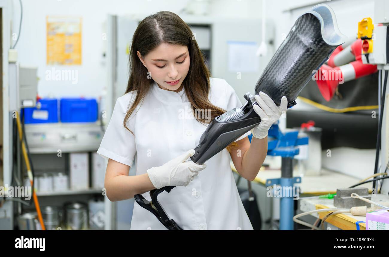 Technician holding prosthetic limb checking and working in laboratory ...