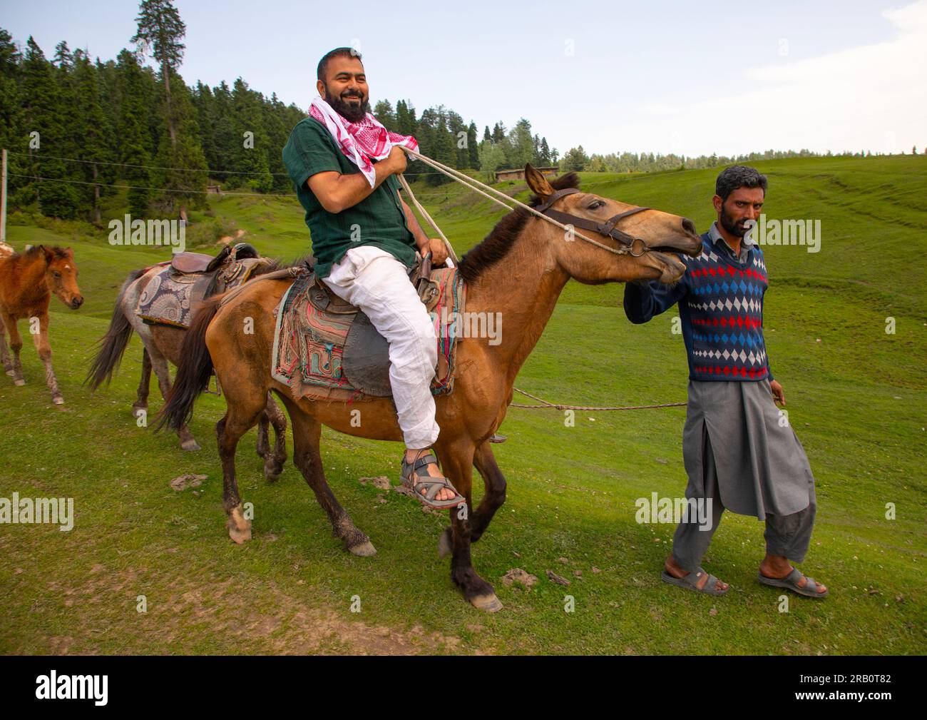 Indian tourist riding a horse, Jammu and Kashmir, Yusmarg, India Stock ...
