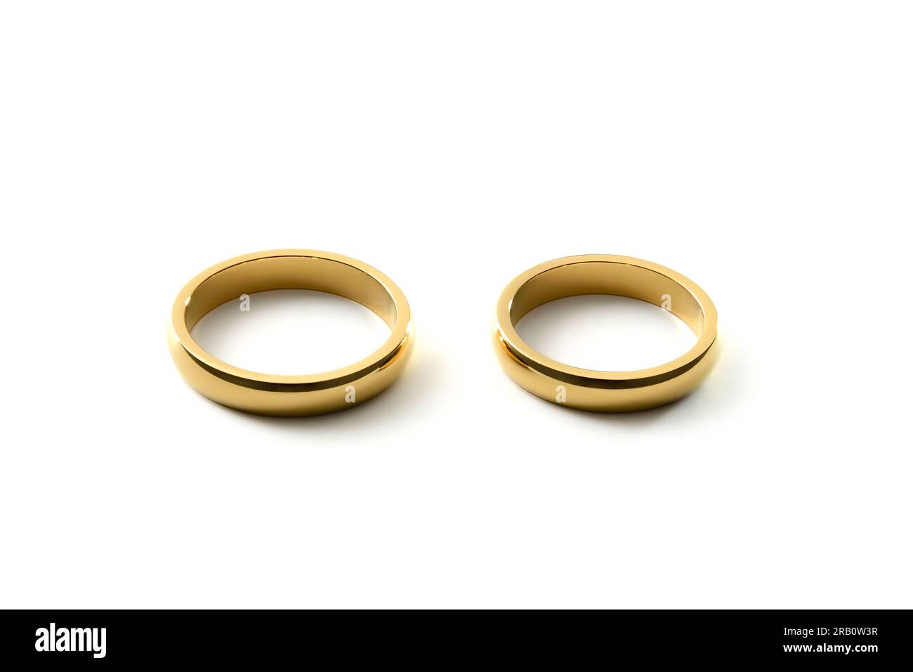 Detail of engagement gold rings side by side on white isolated ...