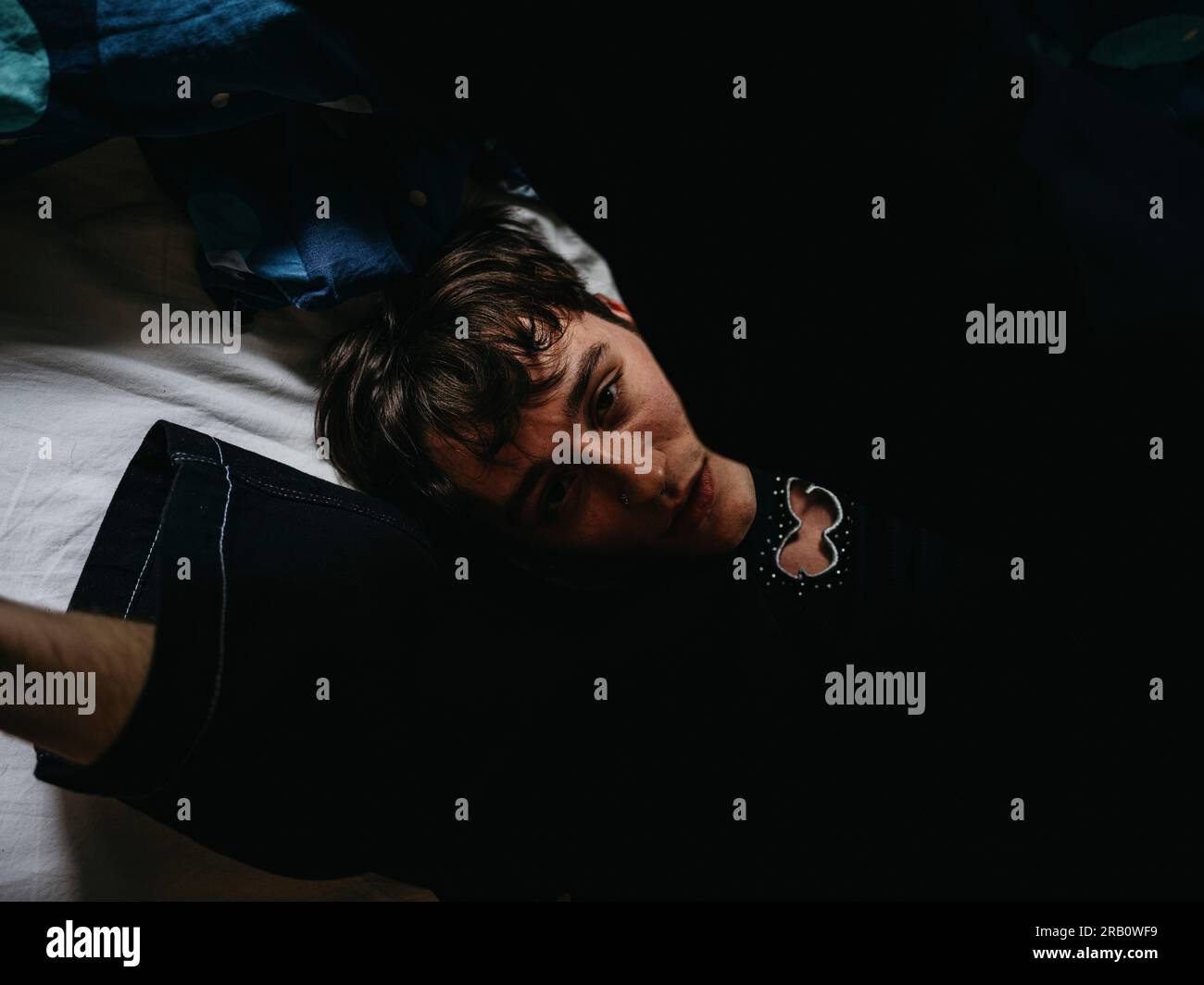 Non-binary person on bed Stock Photo - Alamy