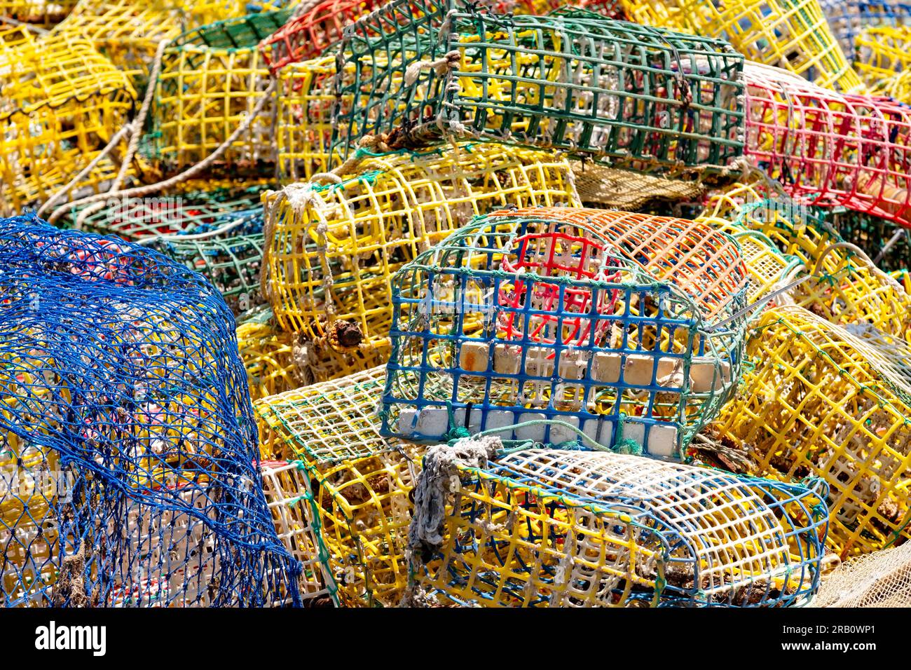 a stack of colourful plastic lobster and crab pots or baskets left to ...