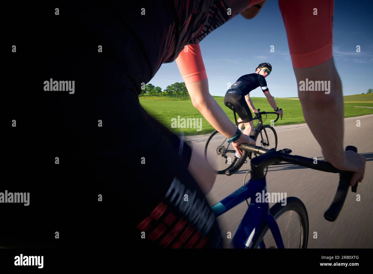 Two young men on racing bikes Stock Photo - Alamy