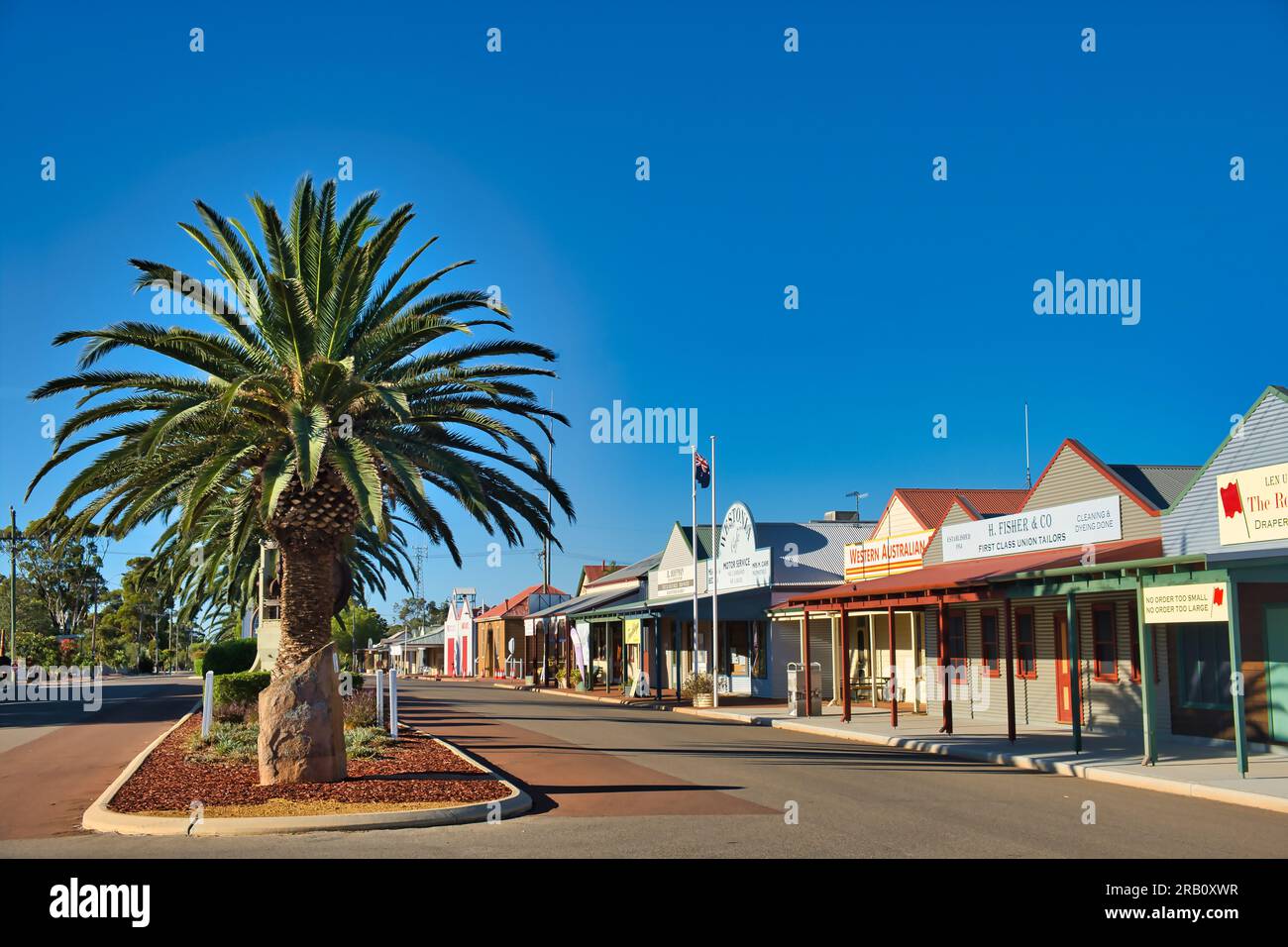 Street scene (Wolfram Street) with shop fronts and palm trees in the ...