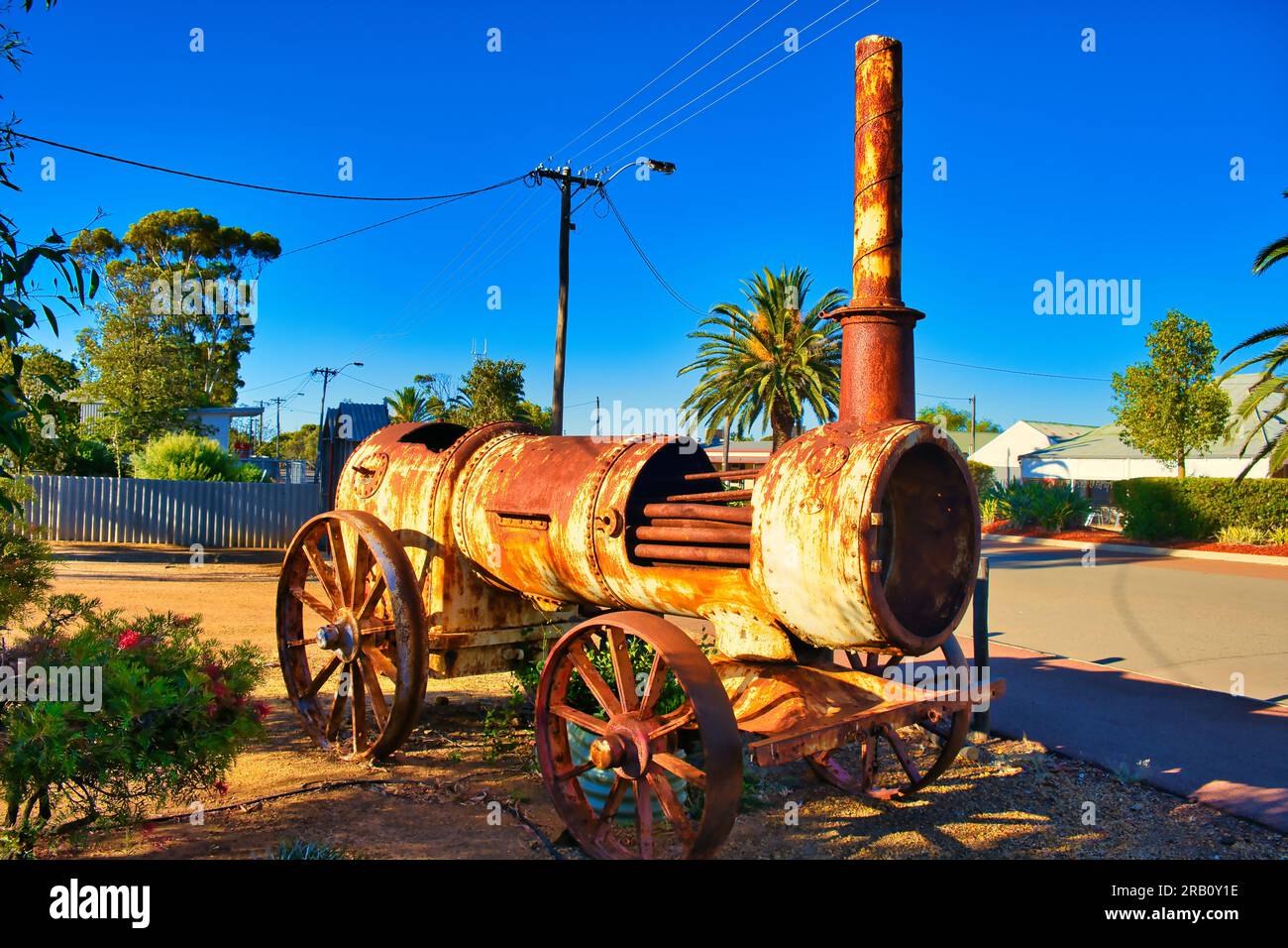 Rusty old steam engine in the setting sun in the outback mining town of ...