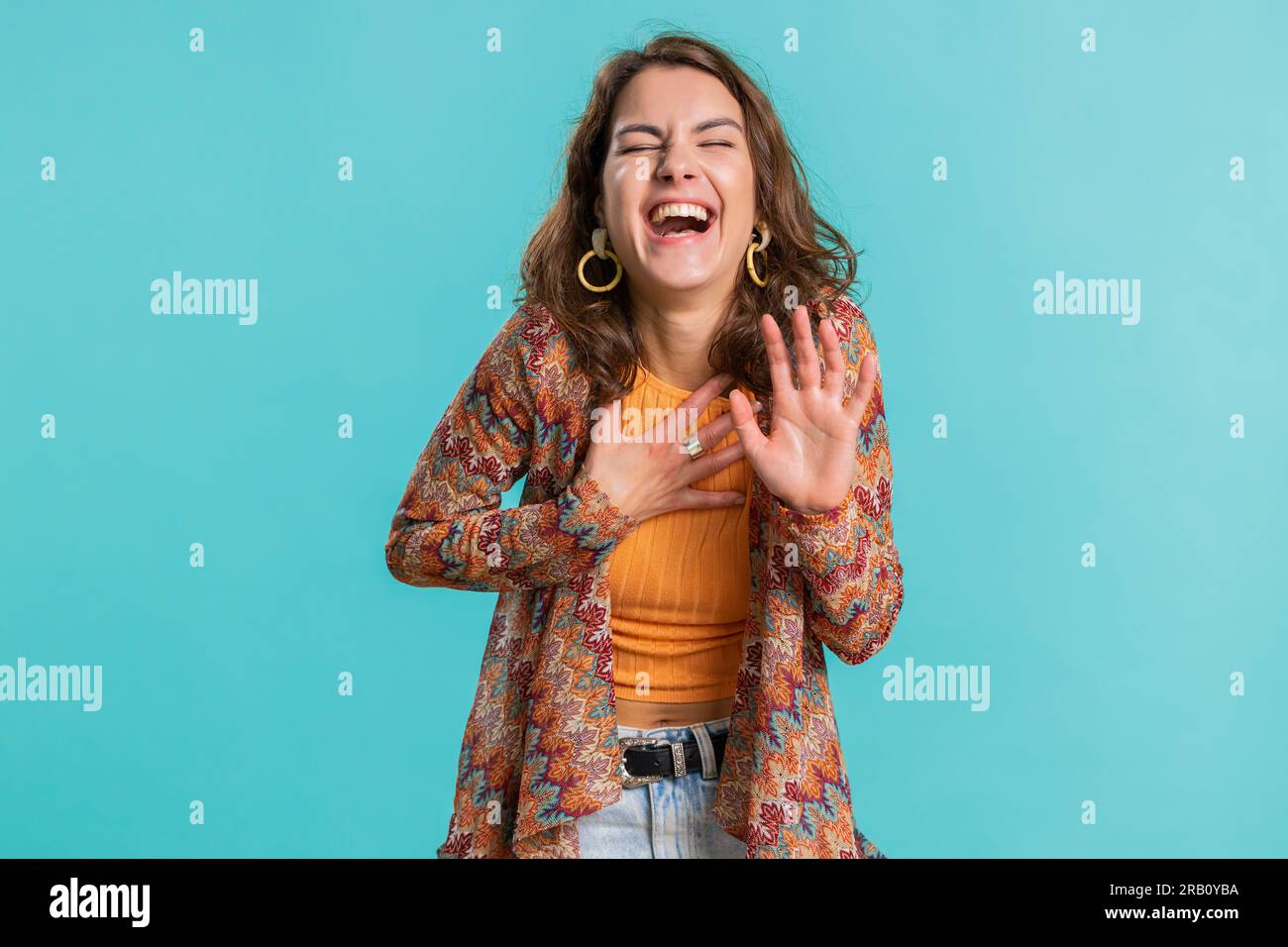 Amused lovely woman pointing finger to camera, laughing out loud ...