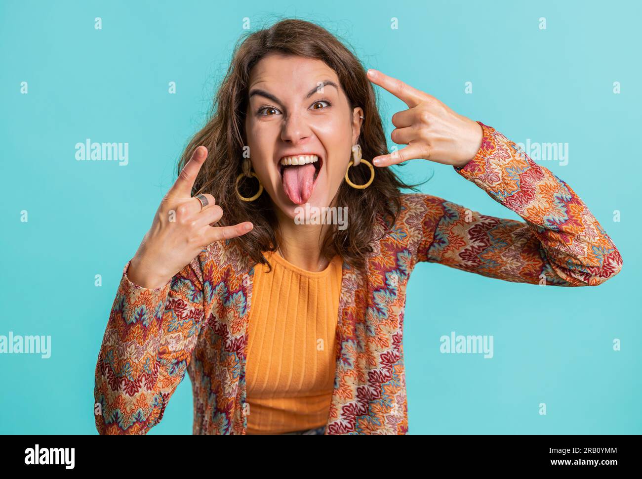 Overjoyed delighted woman showing rock n roll gesture by hands, cool ...