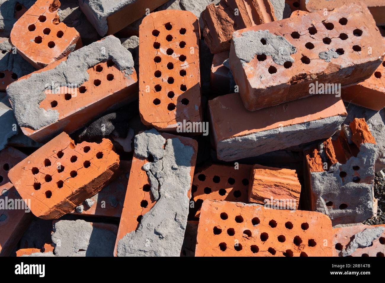 A pile of old red bricks with the remains of dried mortar. Building ...