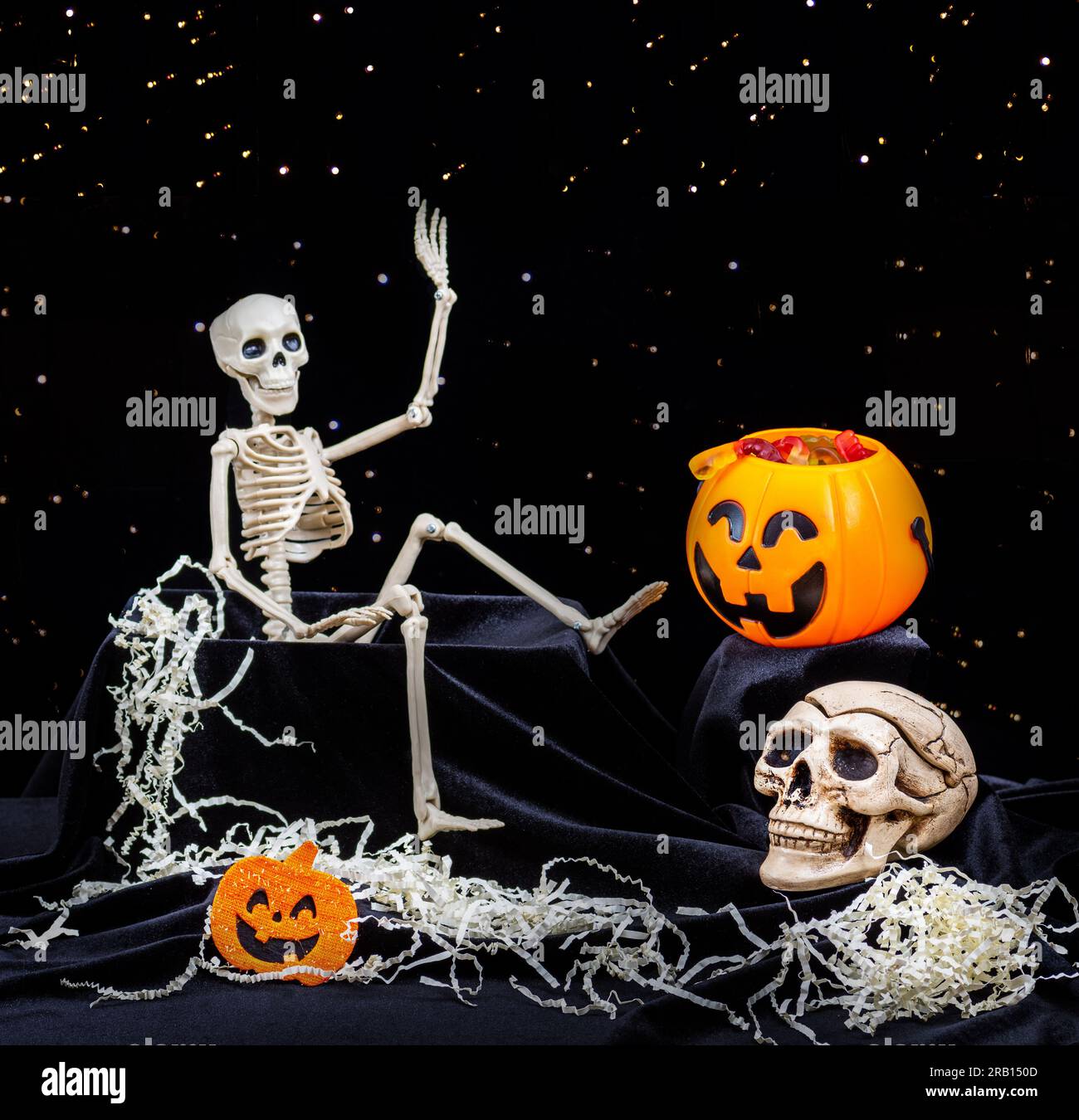 A toy Skeleton crawling out of the grave, and waving his hand, greets ...