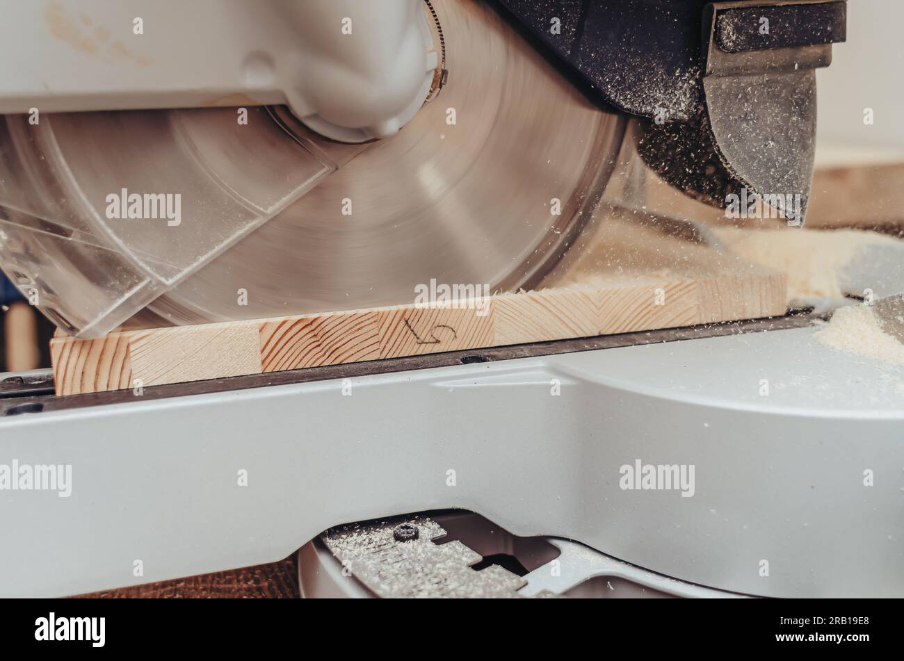 Carpentry machine. Sharp blade of circular saw cuts wooden board. High ...