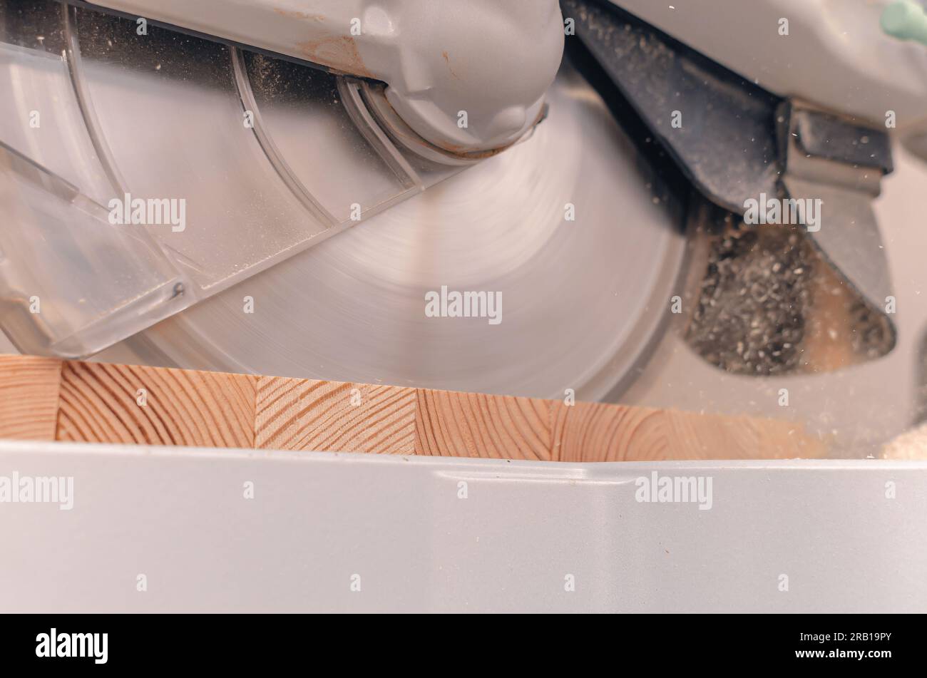 Carpentry machine. Sharp blade of circular saw cuts wooden board. High ...