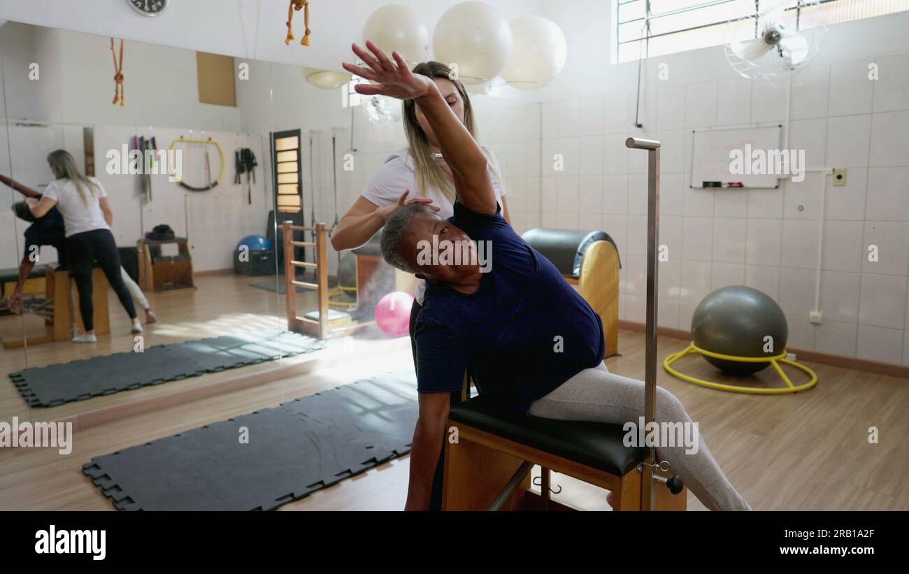 Pilates instructor coaching black elderly hi-res stock photography and ...