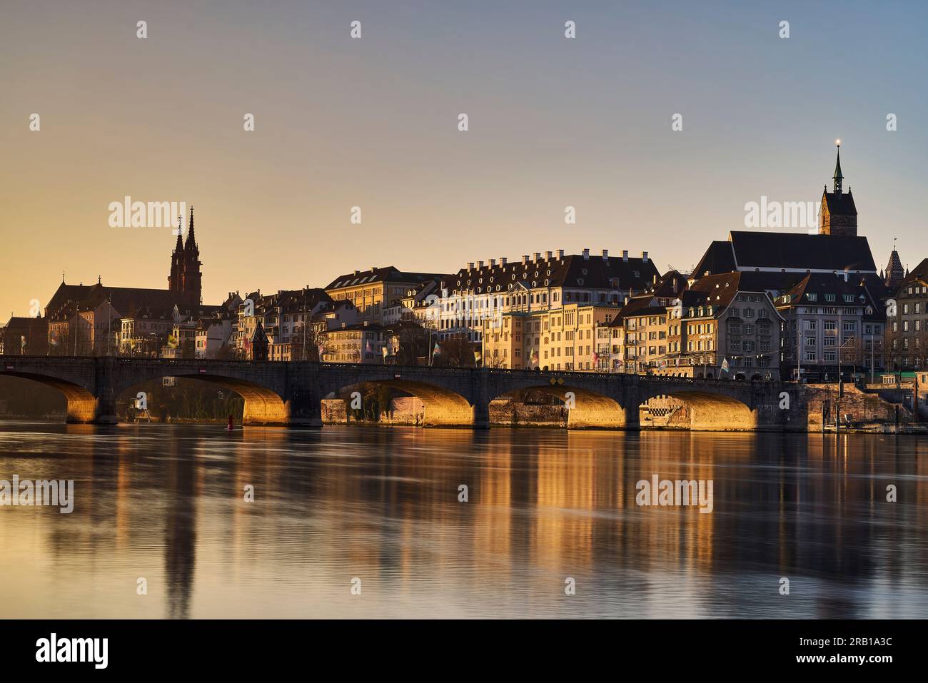 Early morning in Basel at the middle bridge, the arches of which are ...