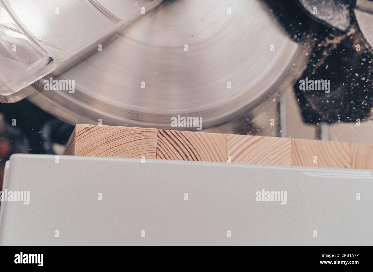 Sharp blade of circular saw cuts wooden board. High rotation speed ...