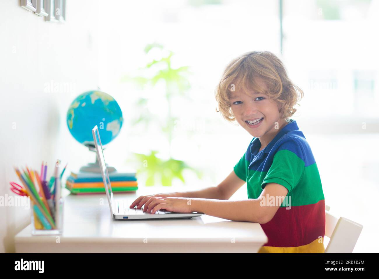 Child doing homework on computer. Online class. Homeschooling and ...