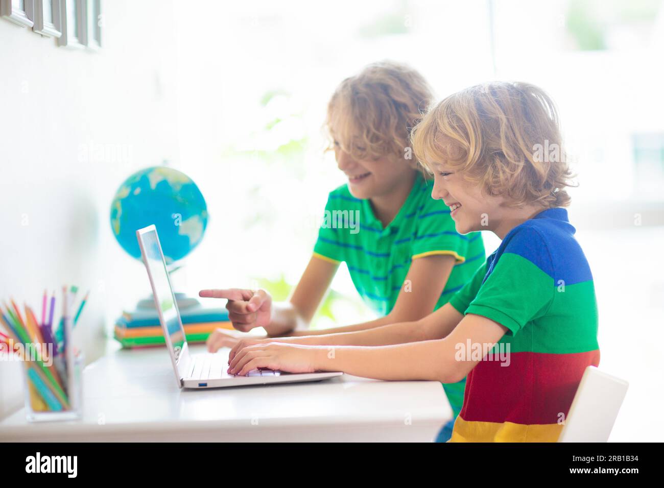 Child doing homework on computer. Online class. Homeschooling and ...