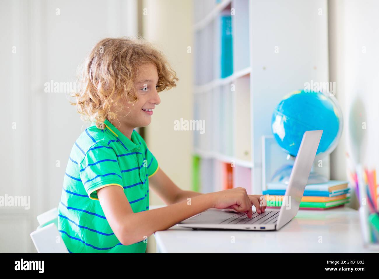 Child doing homework on computer. Online class. Homeschooling and ...