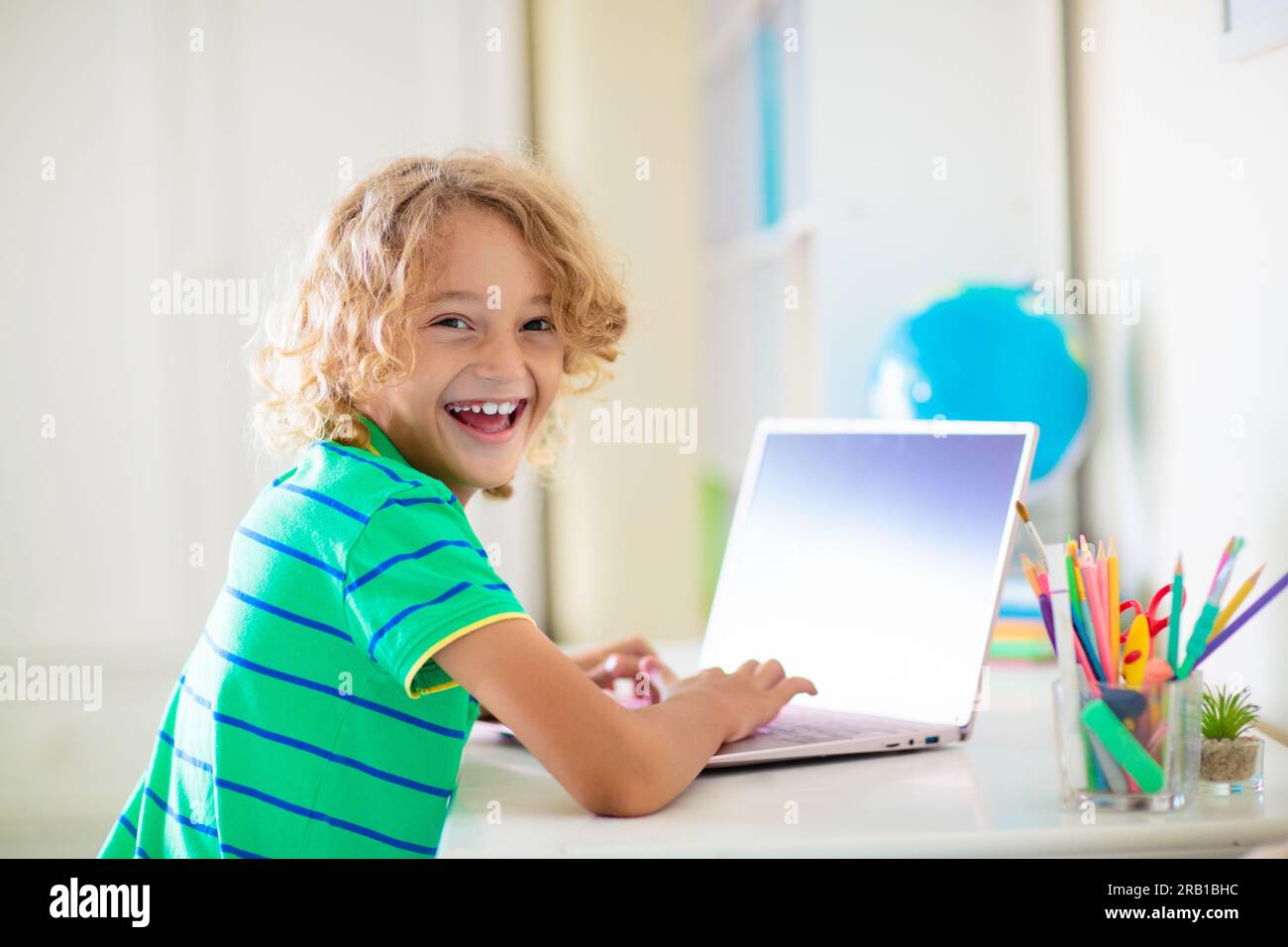 Child doing homework on computer. Online class. Homeschooling and ...