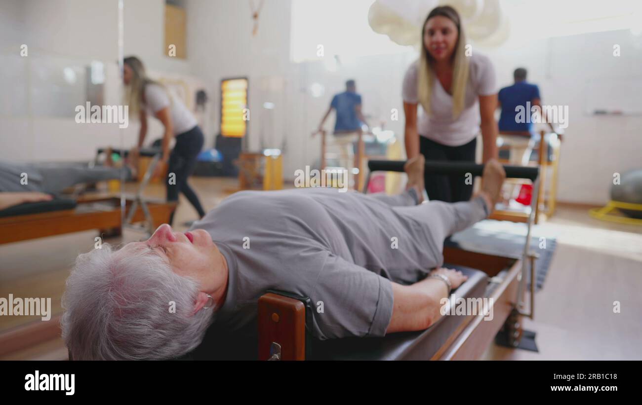 Older woman exercising in Pilates Studio Session. An elderly caucasian ...