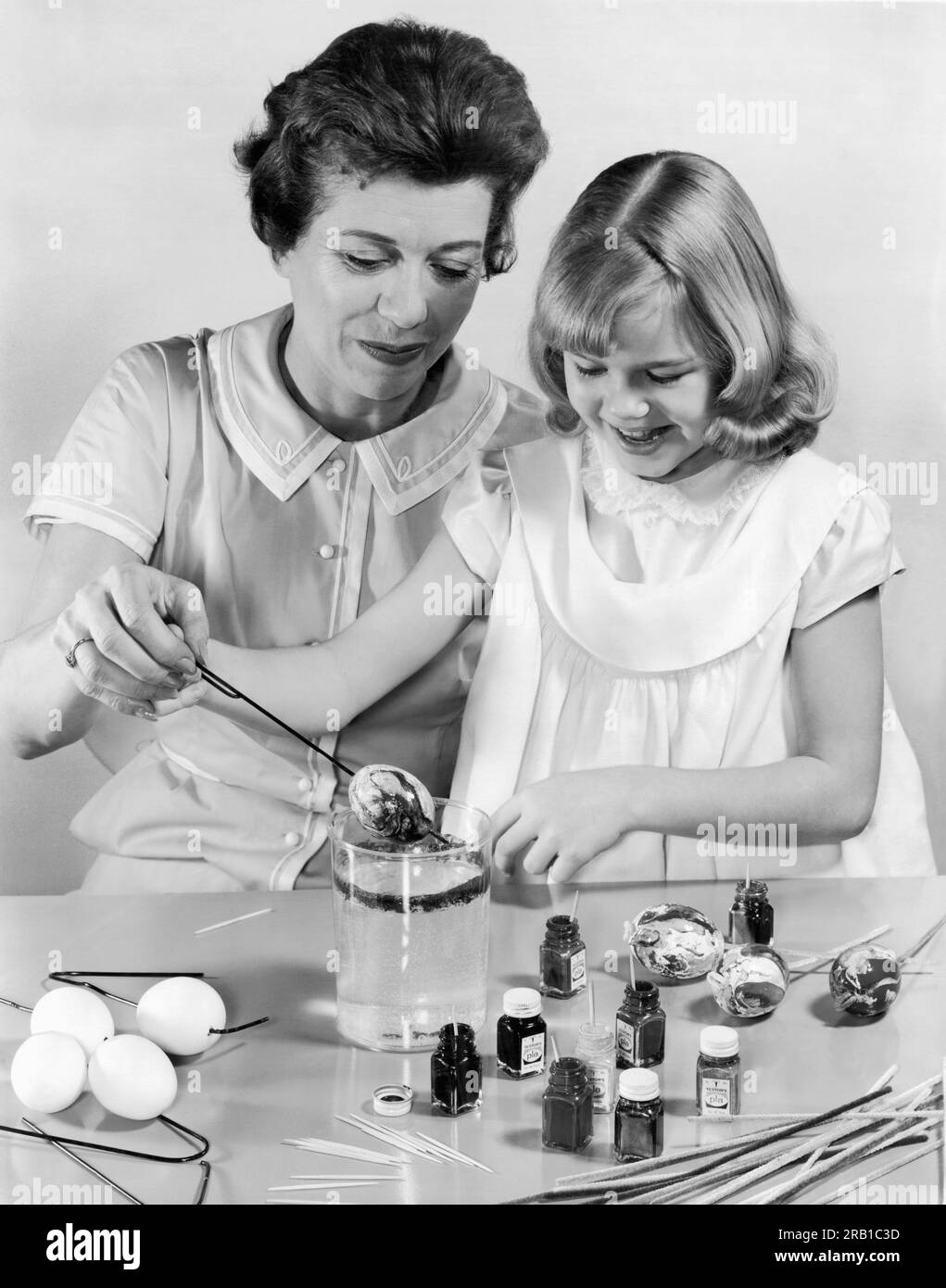 Chicago, Illinois: March 15, 1964 A mother and daughter color eggs in ...