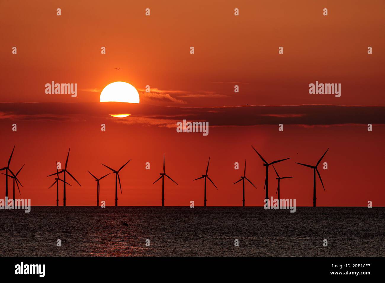 Sunset over the Burbo Bank offshore wind farm, Liverpool Bay, England ...