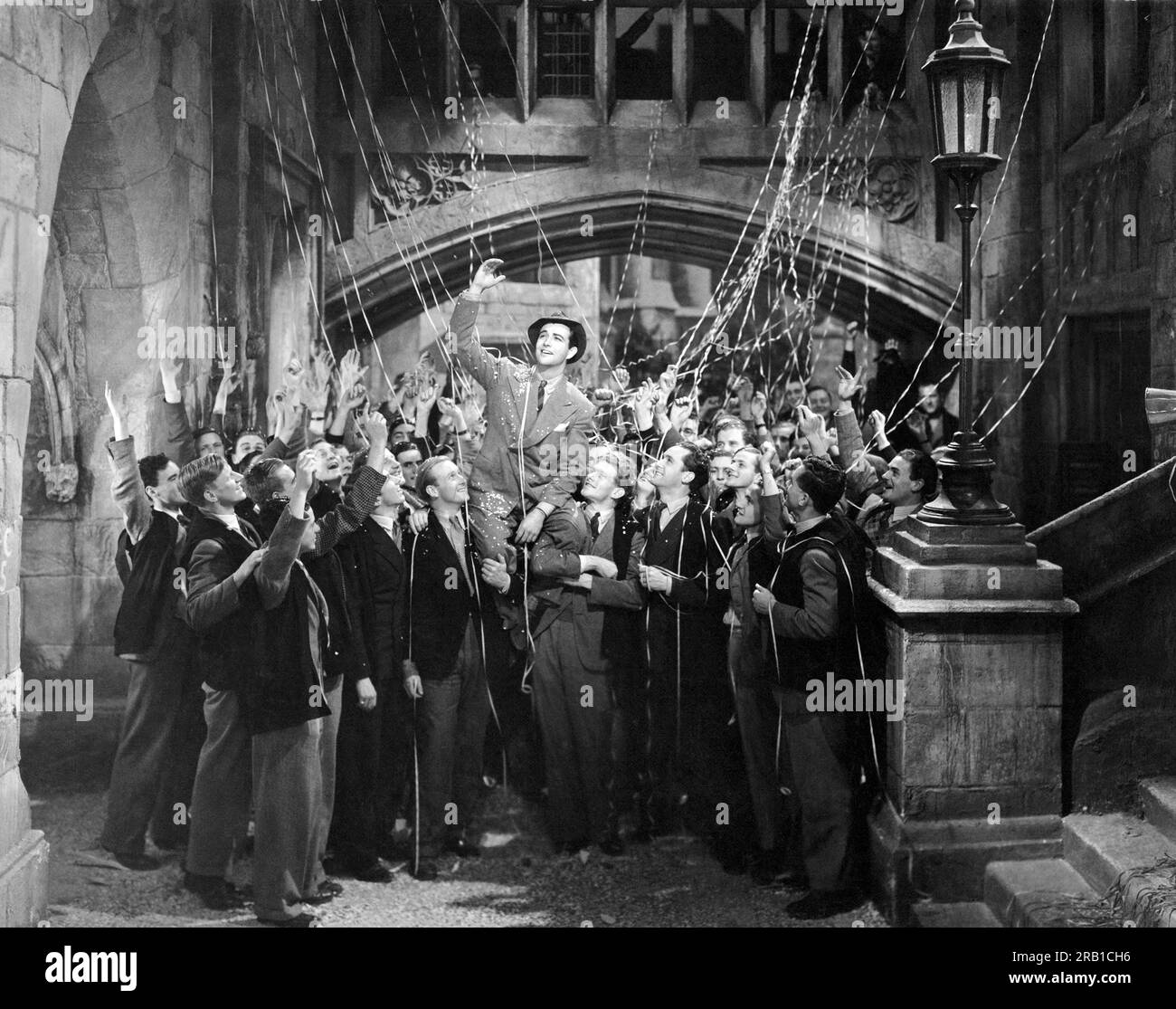 Hollywood, California: c. 1927 A man is hoisted onto shoulders and ...