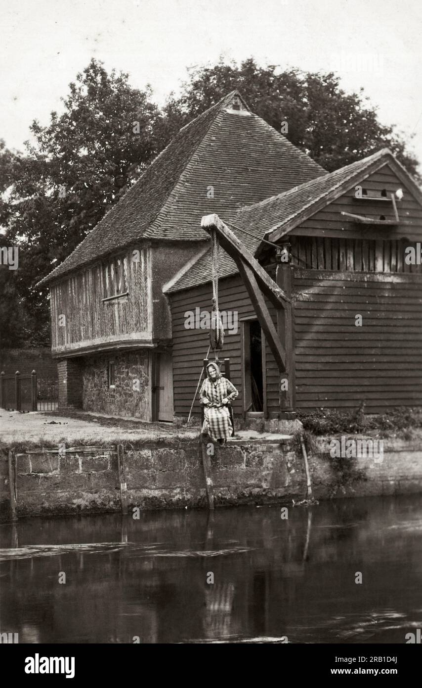 Fordwich, England: c. 1900 A woman demonstates the use of the "Ducking ...