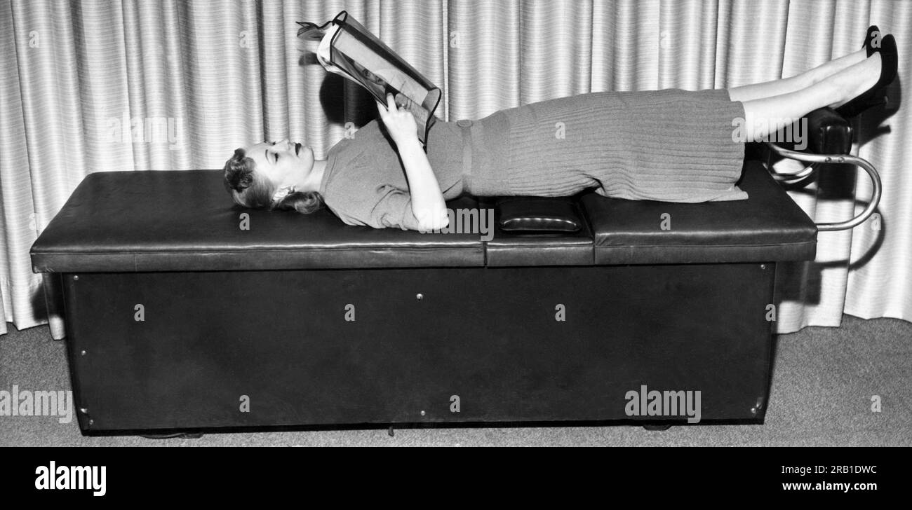 New York, New York: April 20, 1955 A customer lays down on a reducing ...