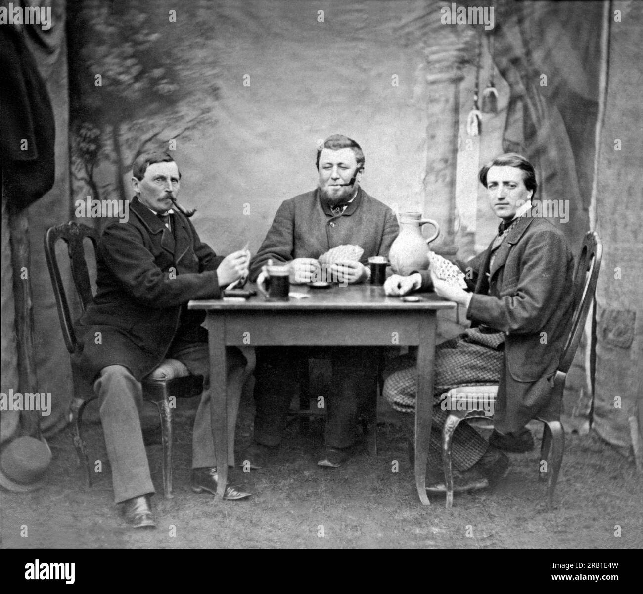 United States: c. 1885. Three men drinking, smoking, and playing cards ...