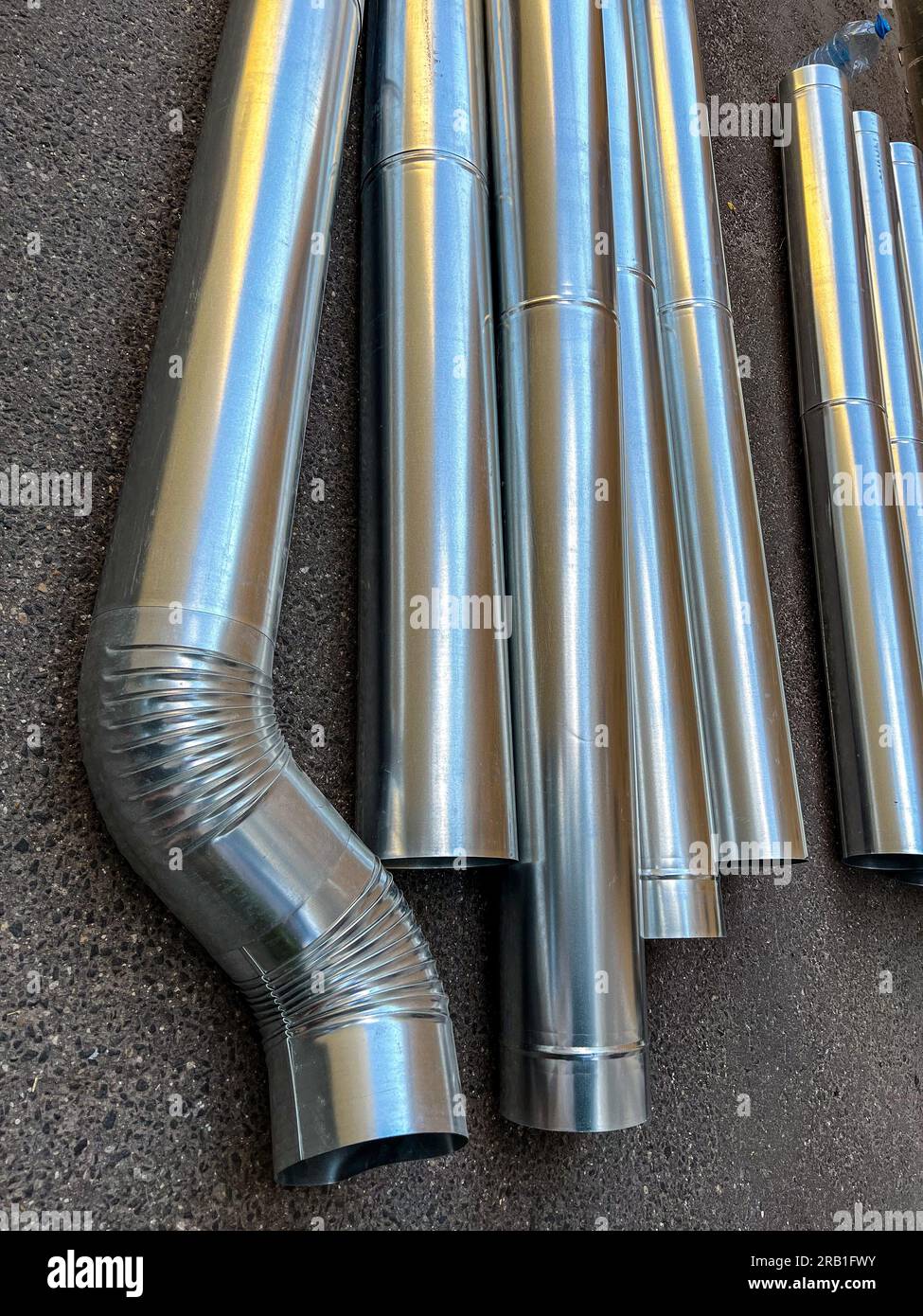 New steel downpipes stacked on the ground Stock Photo - Alamy