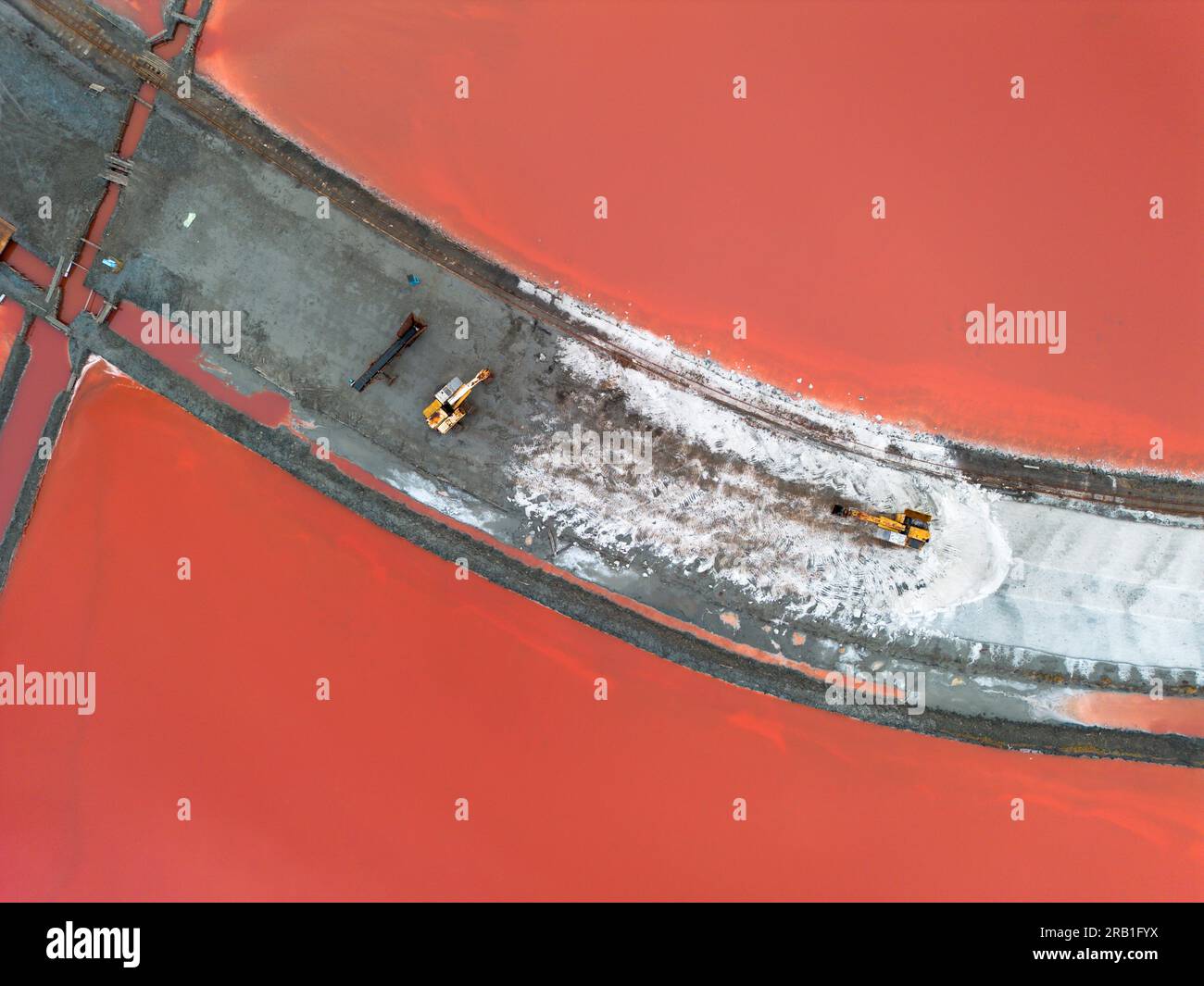 Salt farm excavator top view with salt hill Stock Photo - Alamy