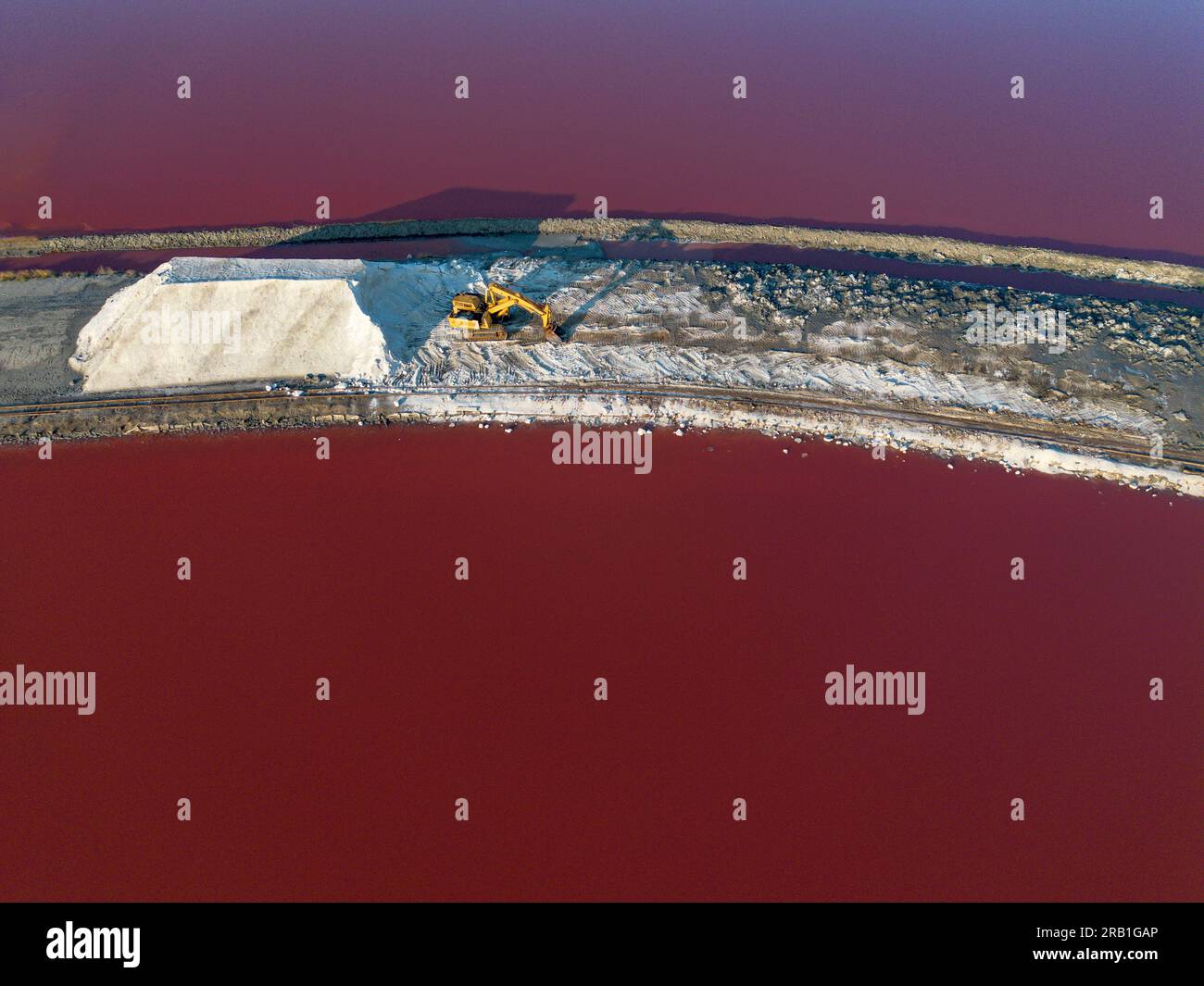 Salt farm excavator top view with salt hill Stock Photo - Alamy