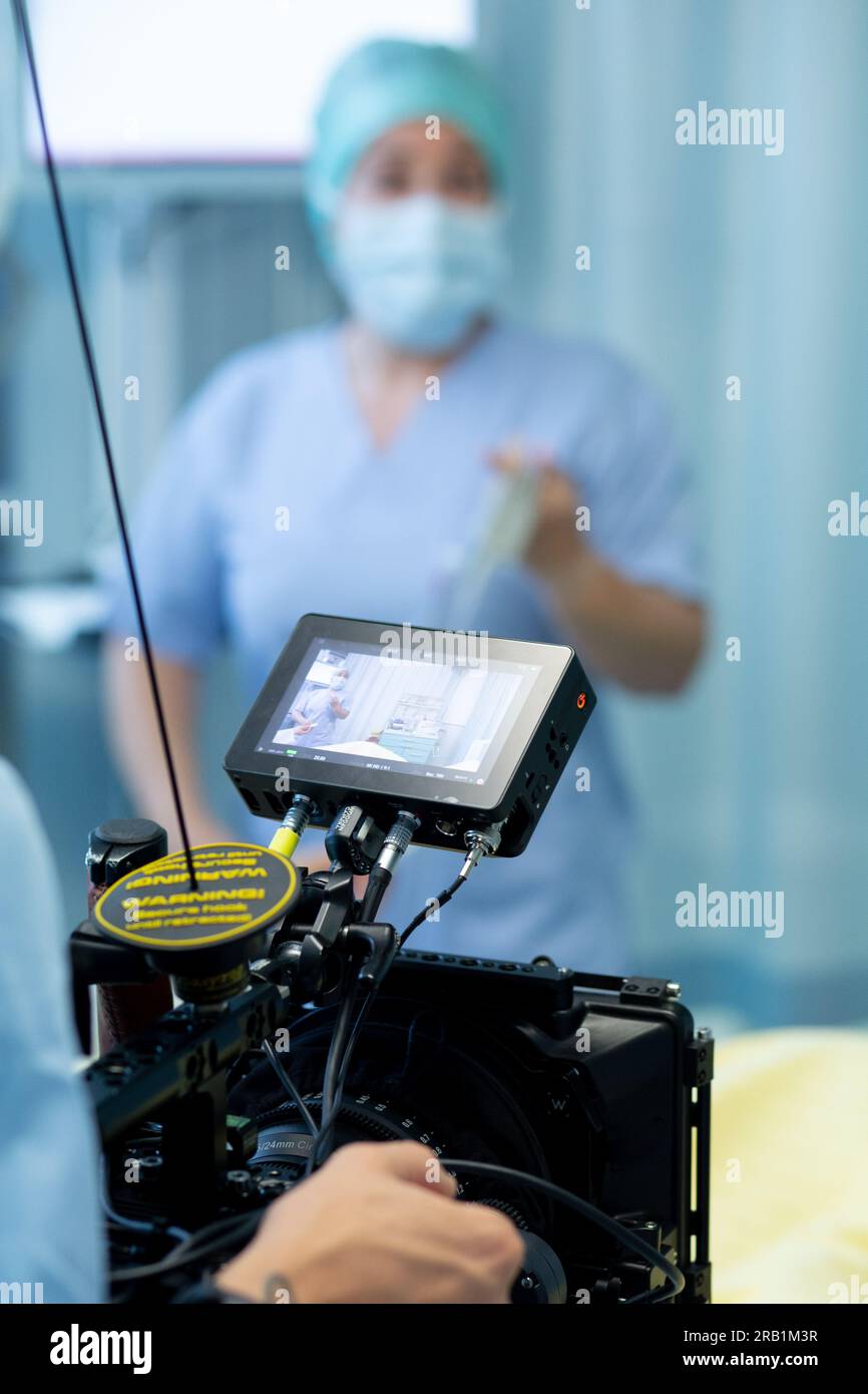 Cameraman shooting a hospital series with nurse in background Stock ...