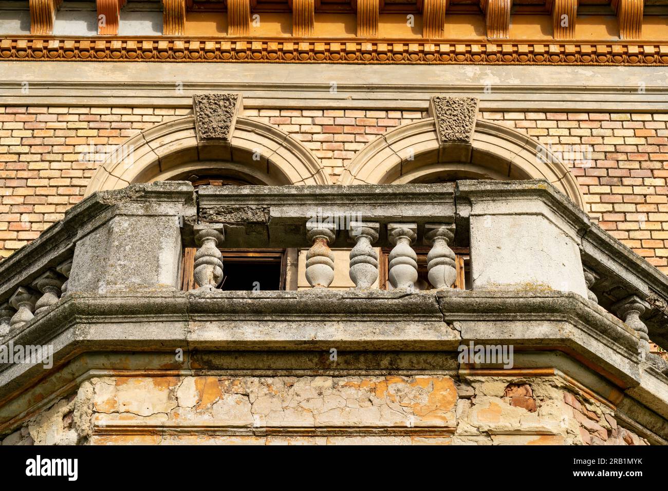 Abandoned dilapidated orange country mansion in afternoon sun with ...