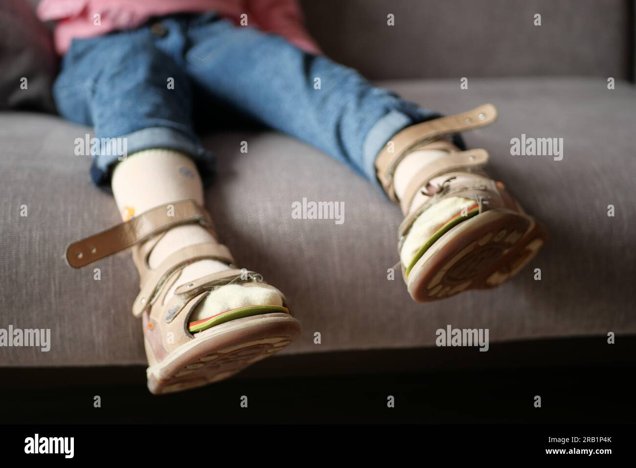 Child cerebral palsy disability, legs orthosis Stock Photo - Alamy