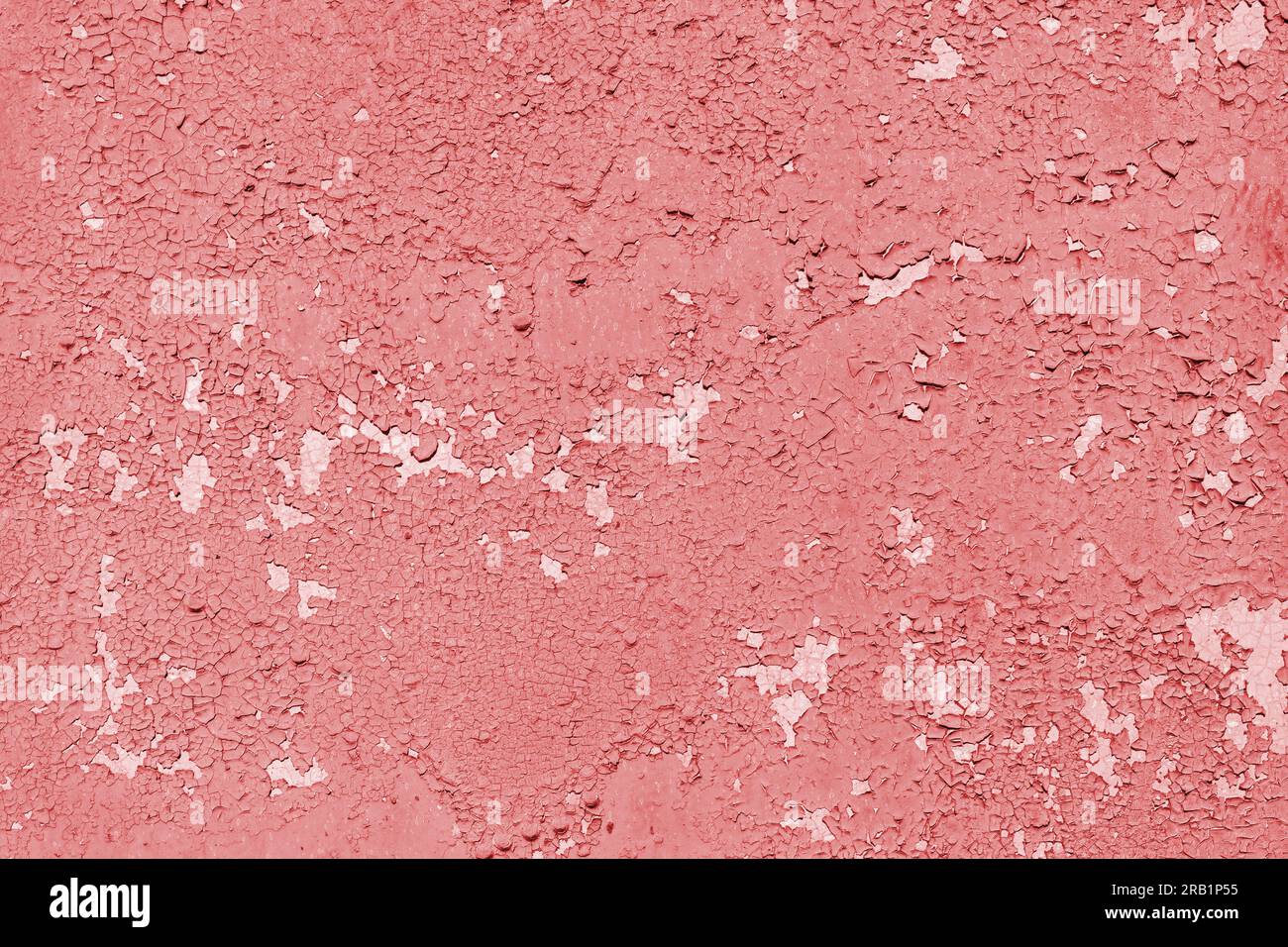Concrete wall with old cracked, peeling flaking red paint. Weathered rough painted surface with ...
