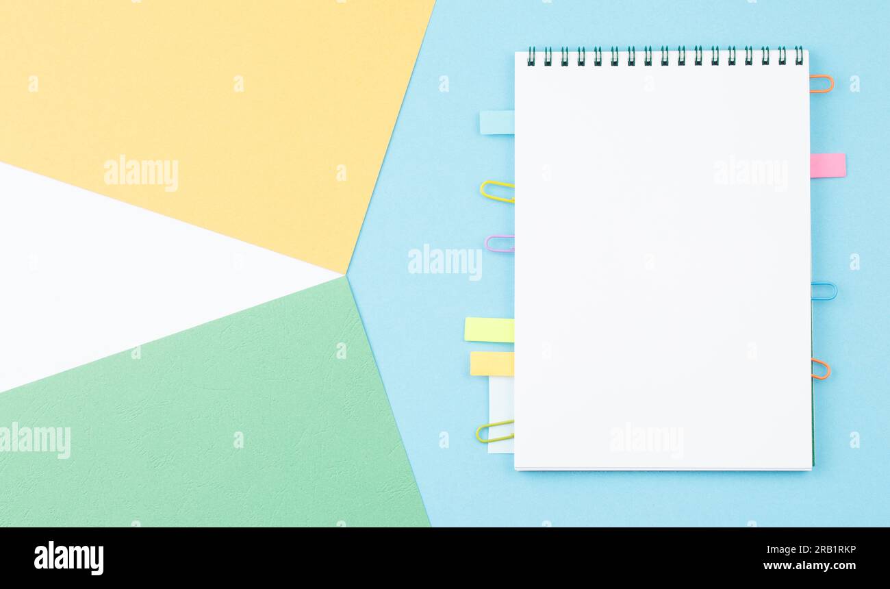 Spiral notepad on color background Stock Photo - Alamy
