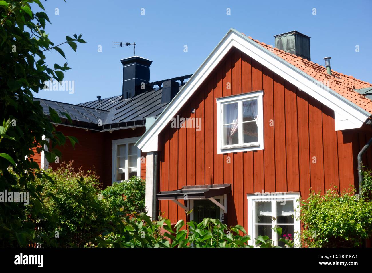 Gable of a traditional vintage falu red house with white corners and ...