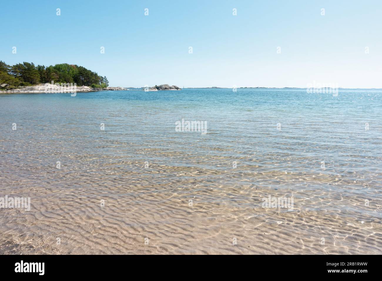 Clear blue turquoise water by white sand beach on Sandhamn island in ...