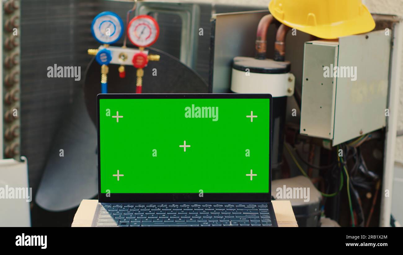 Chroma key laptop in front of unfunctional opened external air ...