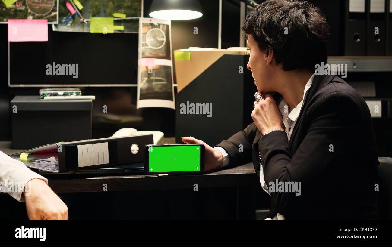 Criminal investigators with greenscreen working to uncover new clues ...