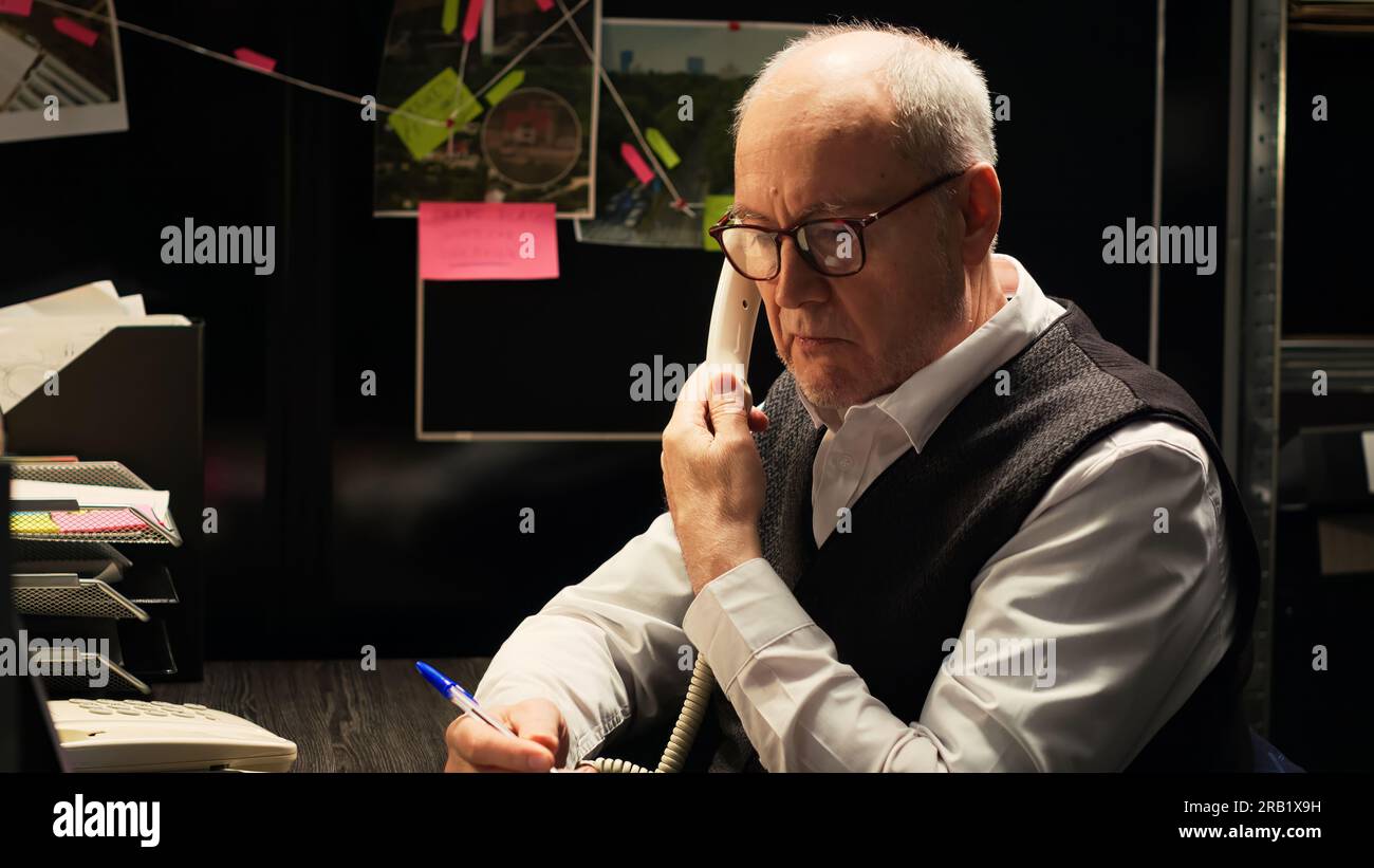 Private detective gathering intelligence from landline phone call ...