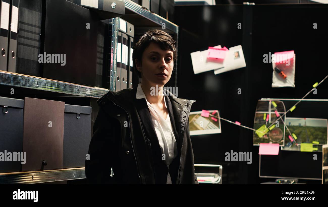 Woman inspector planning detective work, analyzing classified evidence ...