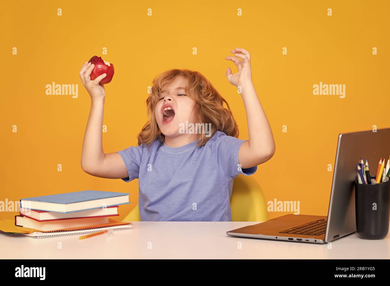 Excited funny pupil. Little student school child isolated on studio ...