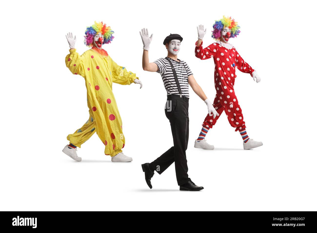 Full length shot of two clowns and a mime walking and waving isolated on white background Stock ...
