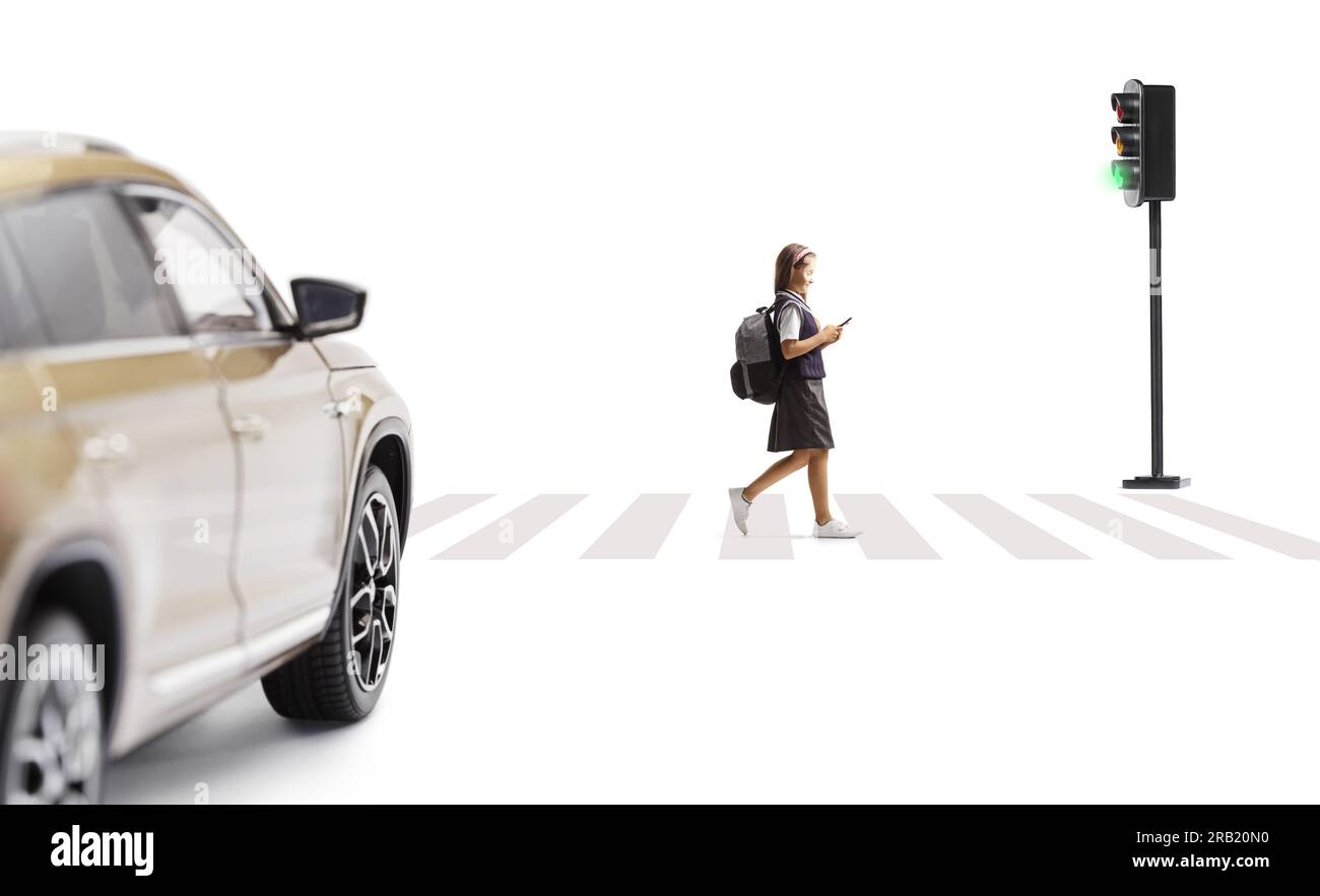 Student crossing a street and using a smartphone and car driving ...